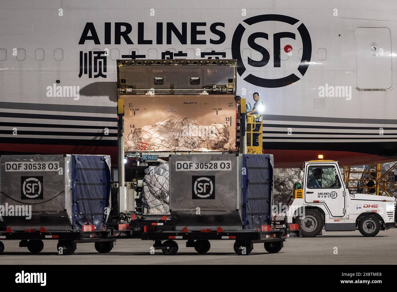 Staff members of SF airlines load the cargo onto a SF cargo aircraft at ...