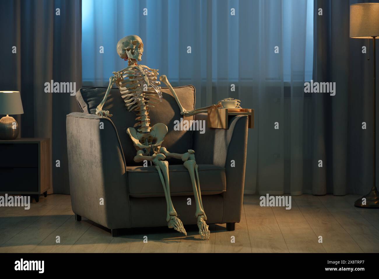 Waiting concept. Human skeleton sitting in armchair indoors Stock Photo ...