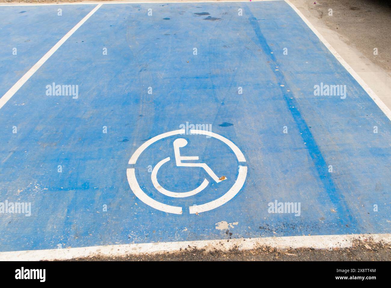disable sign on blue paint color car park Stock Photo - Alamy