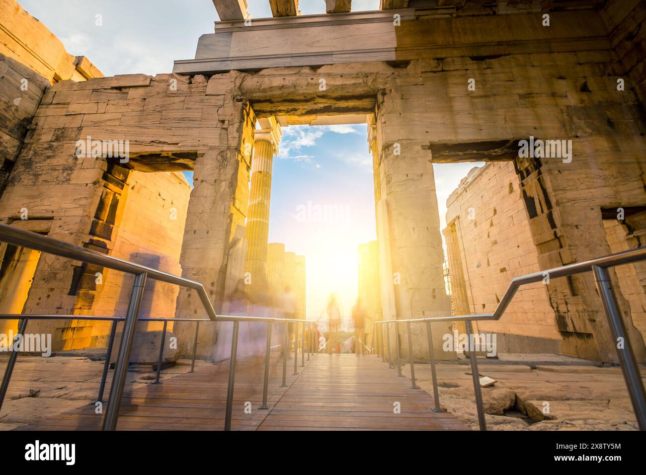Motion blurred photo of tourists pass through the Propylaea monumental ...