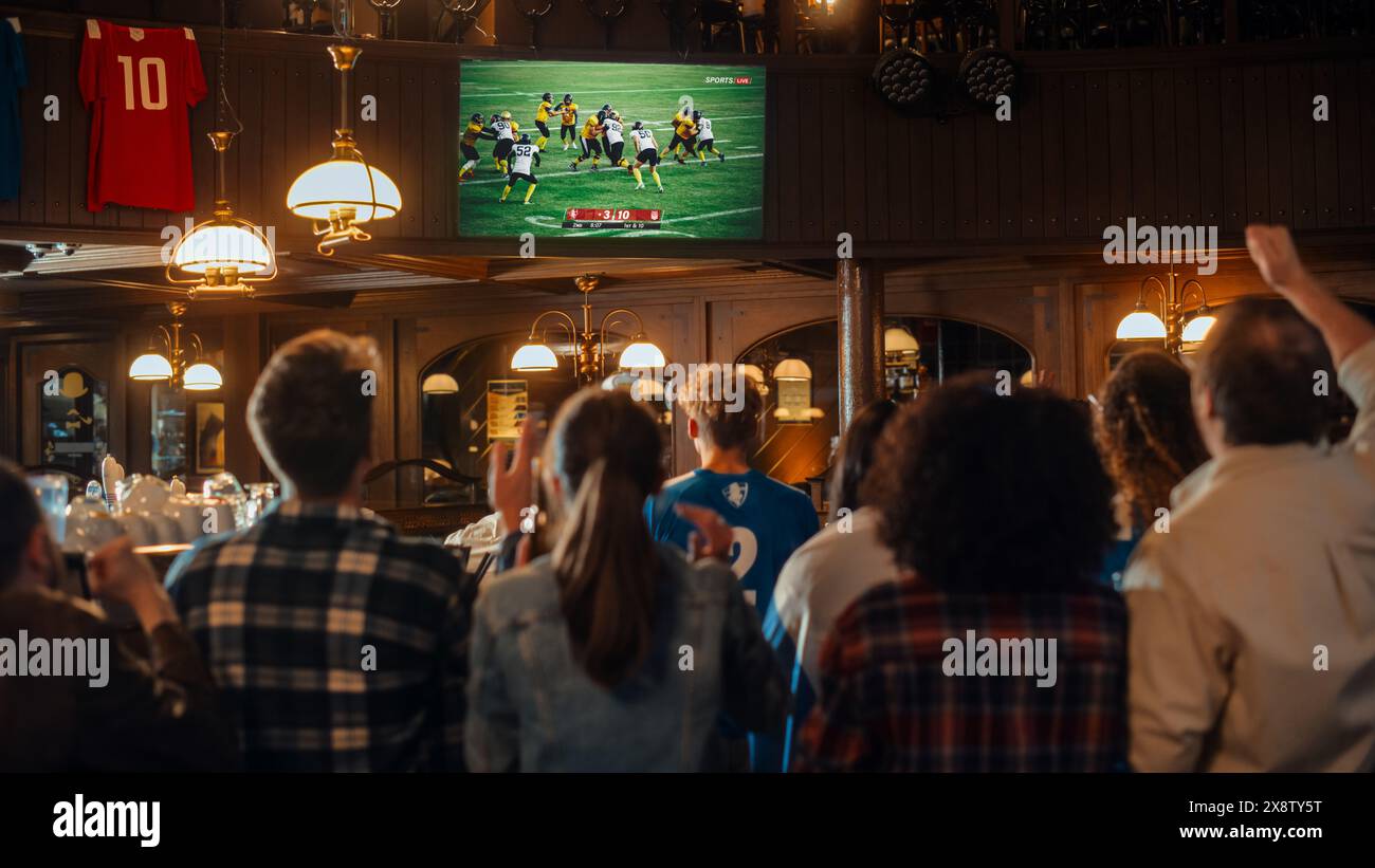 Group of American Football Fans Watching a Live Match Broadcast in a ...