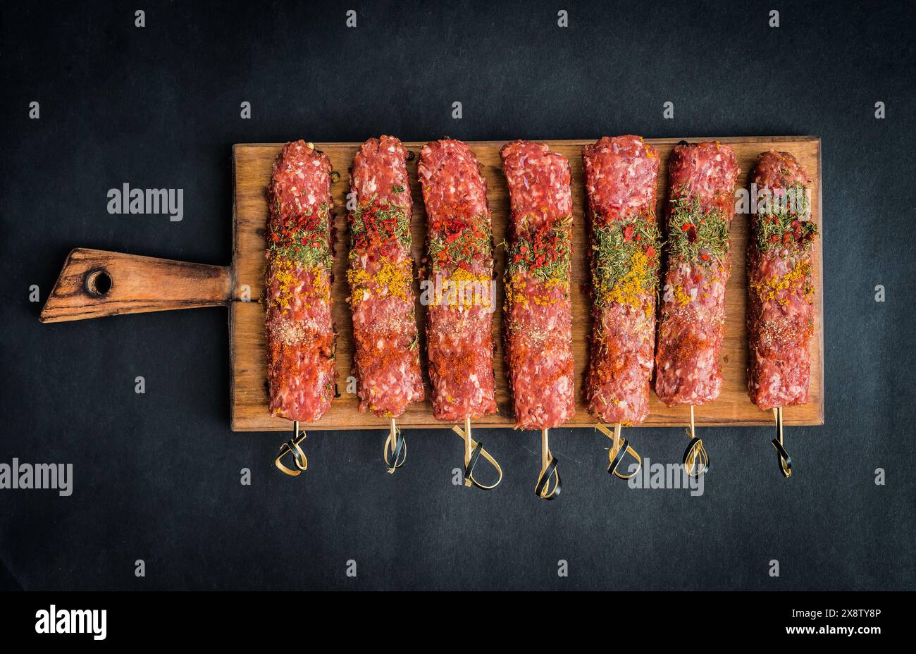 Raw kebab with spices on a board Stock Photo - Alamy