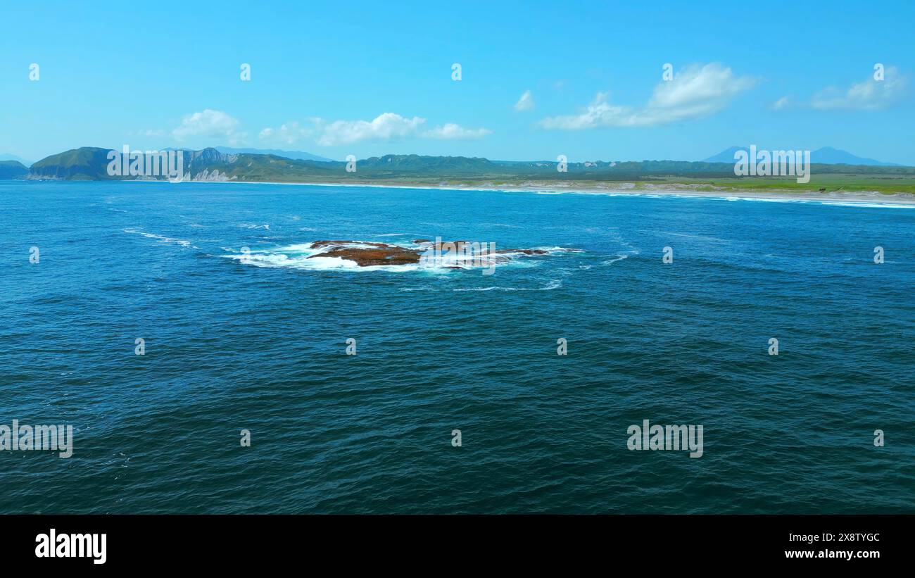 Aerial picturesque seascape with blue water, boulders rising up above ...