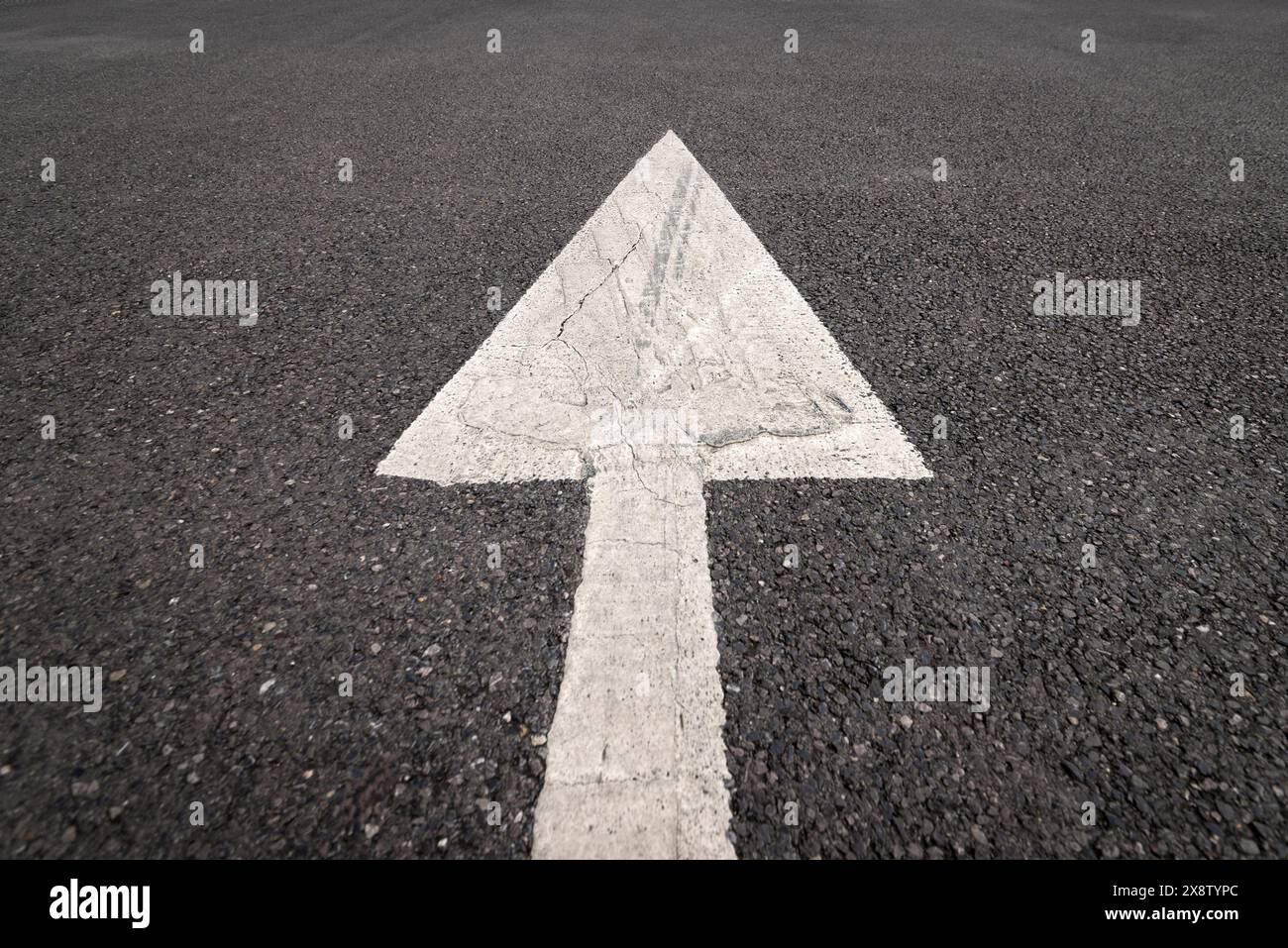 White arrow road marking painted on asphalt Stock Photo - Alamy