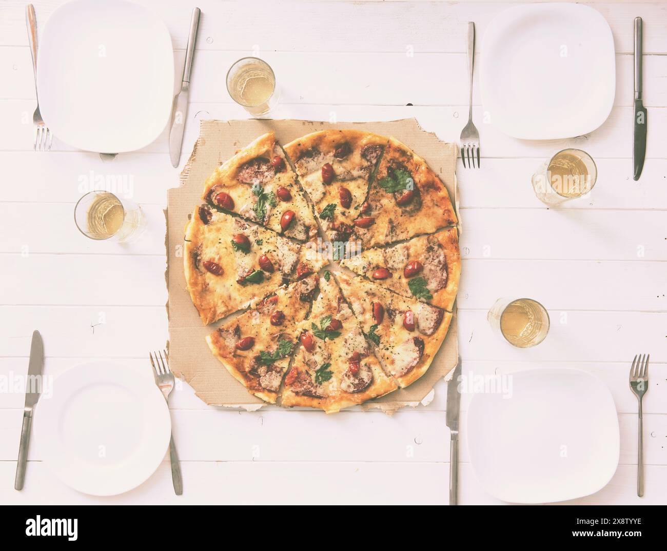 table with pizza set for four persons top view Stock Photo - Alamy