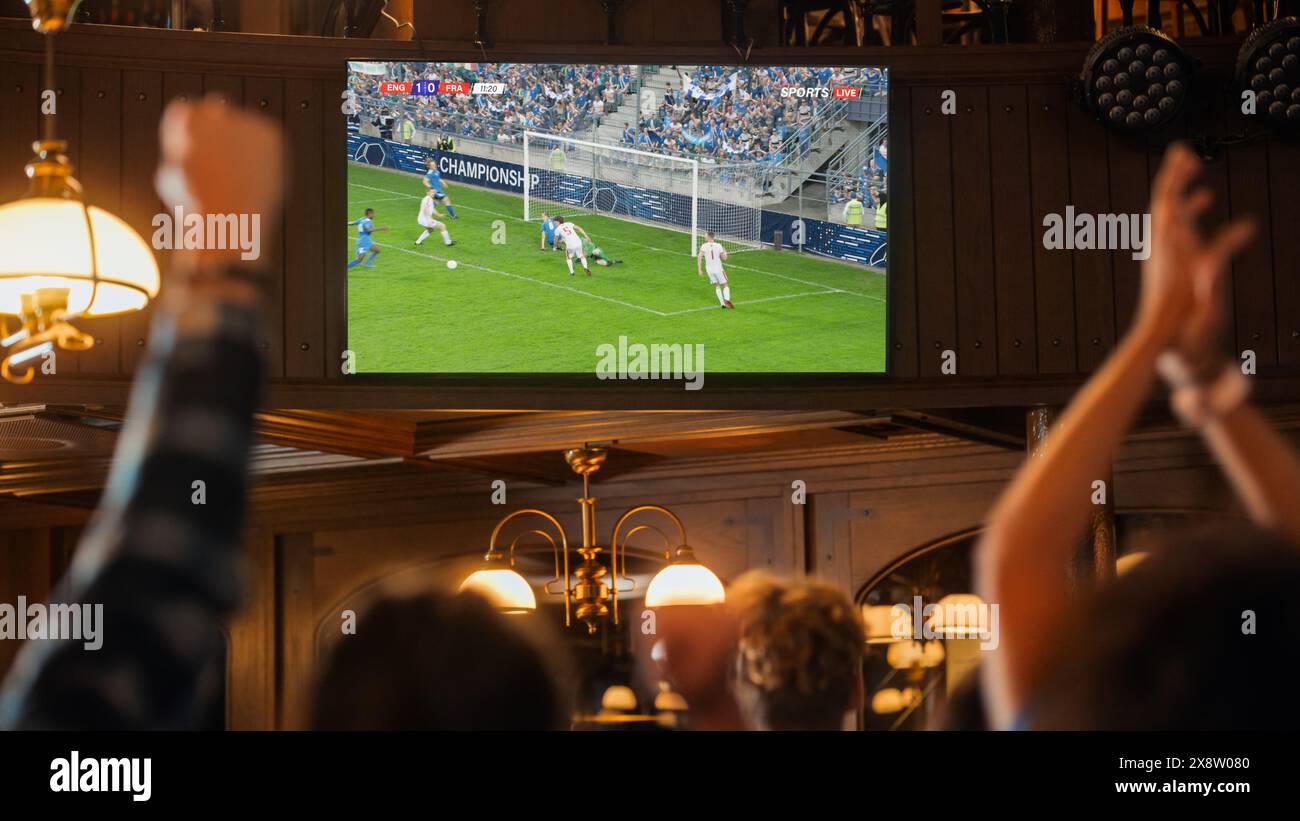 Group of Friends Watching a Live Soccer Match on TV in a Sports Bar ...
