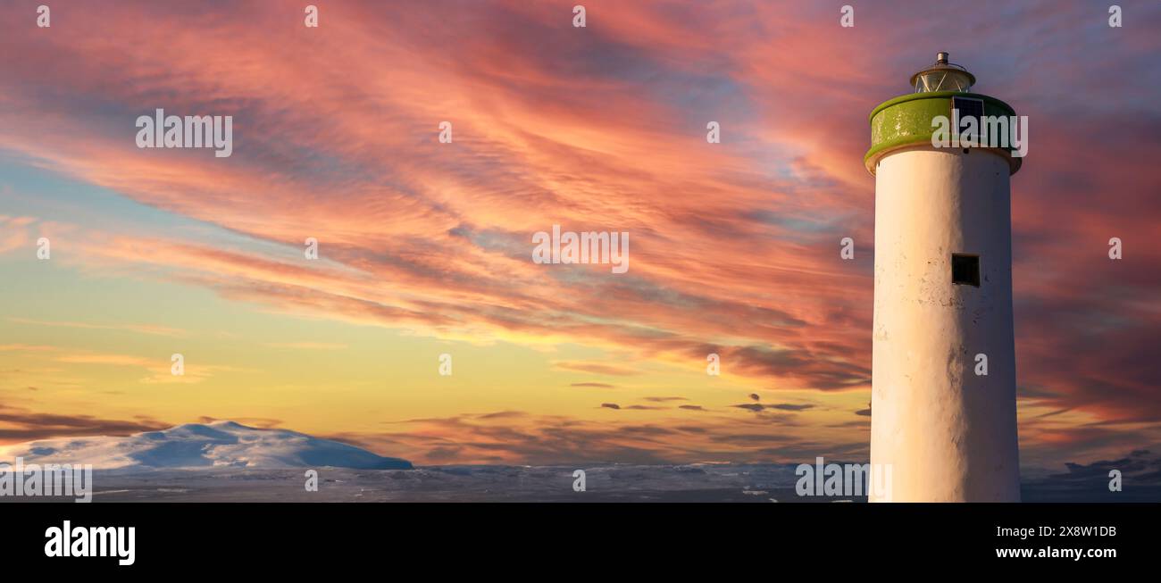 Dramatic sky with a maritime lighthouse at sunset, striking contrast ...