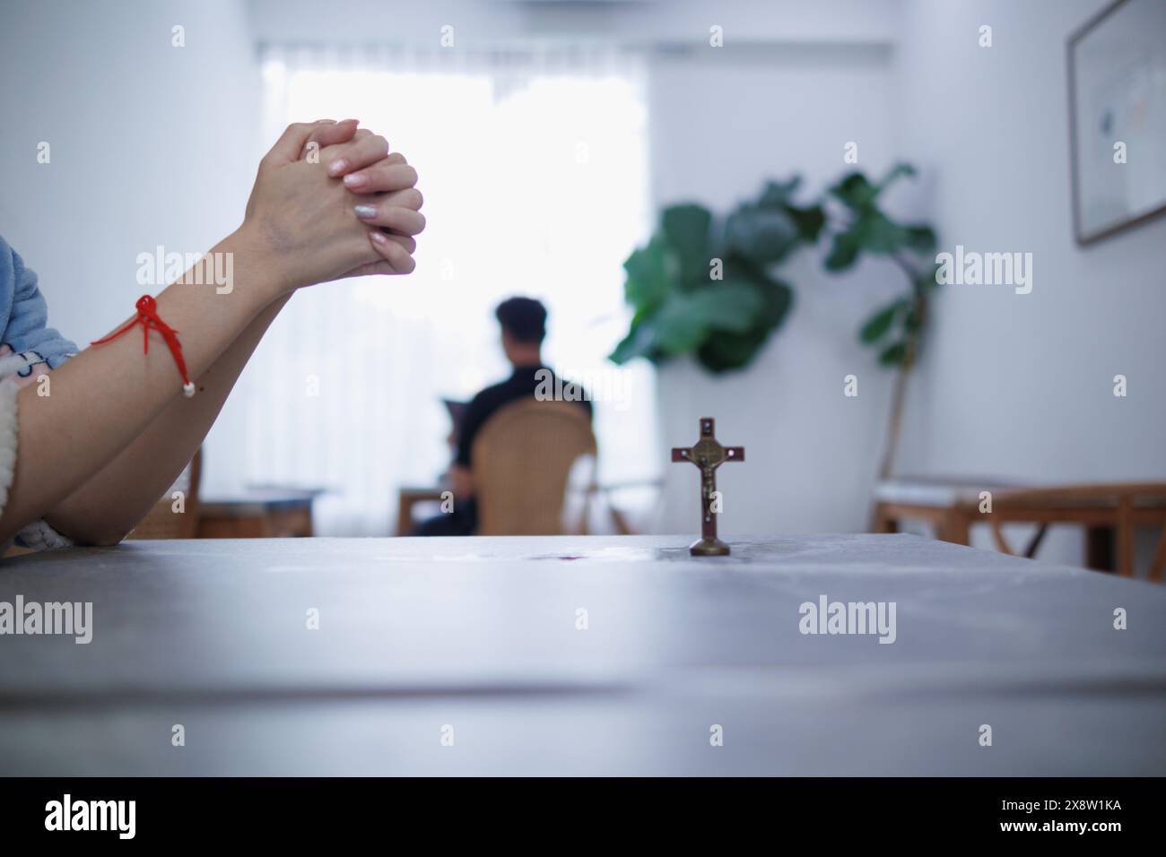 young woman clasped her hands together in prayer asking for forgiveness ...