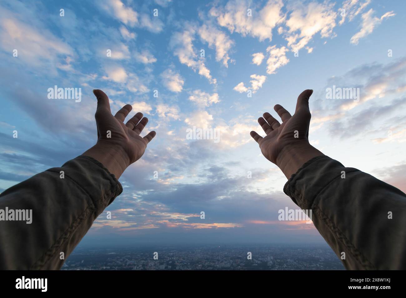 woman raised her hands above her head to ask for mercy from God in ...