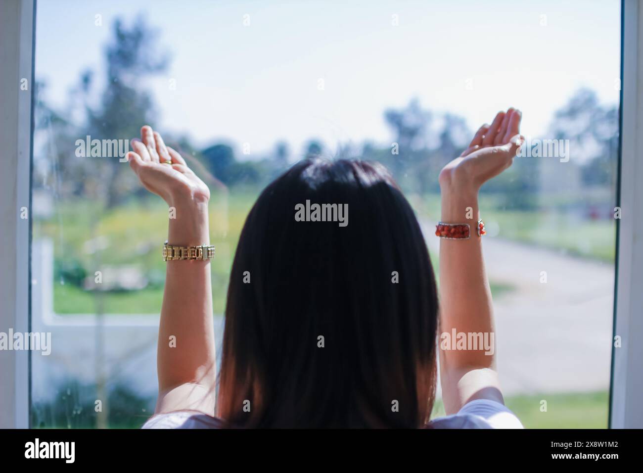 woman raised her hands above her head to ask for mercy from God in ...