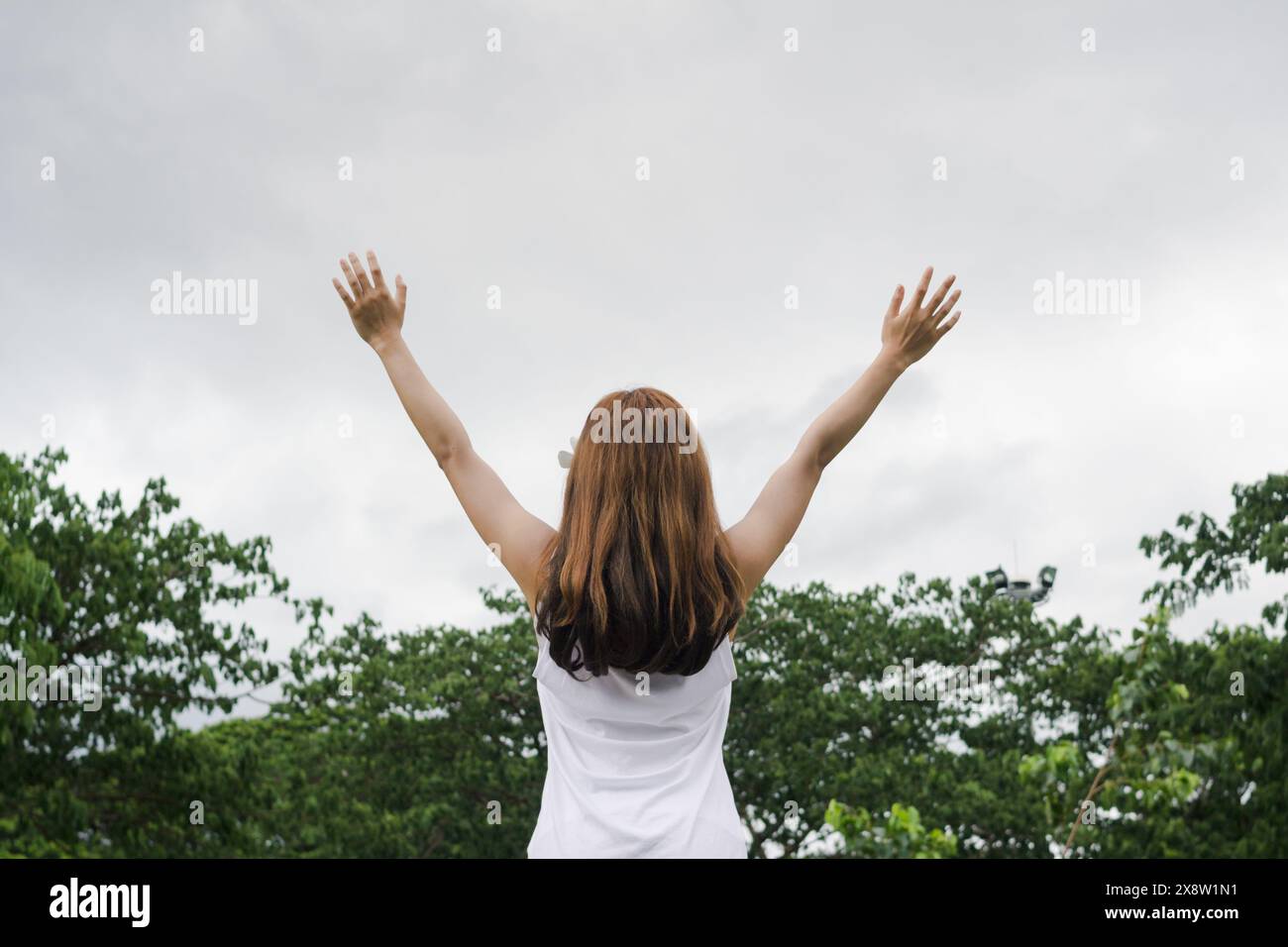 Woman raising hands above head hi-res stock photography and images - Alamy
