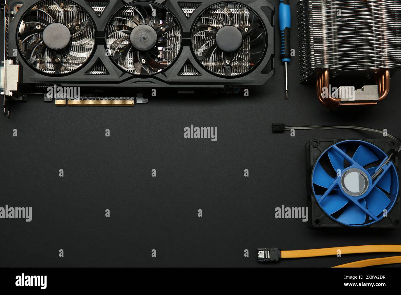 Graphics card and other computer hardware on black background, flat lay ...