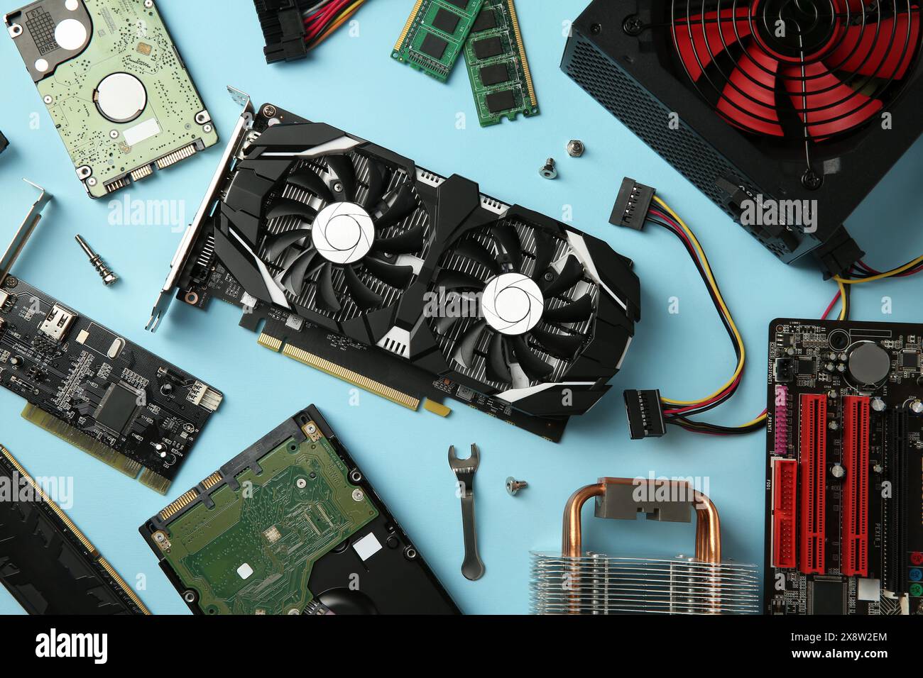 Graphics card and other computer hardware on light blue background ...