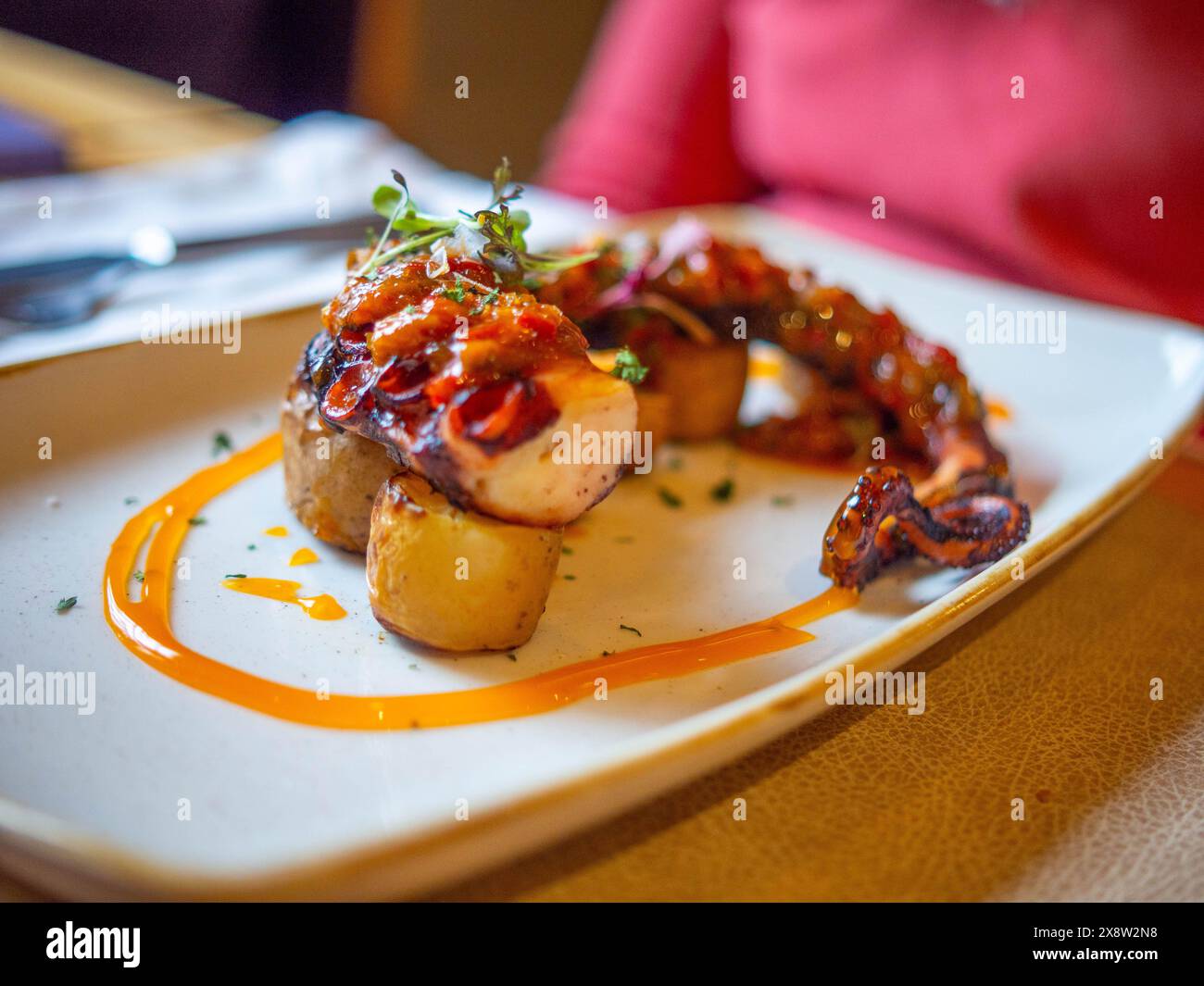 Gourmet octopus and potatoes dish Stock Photo - Alamy