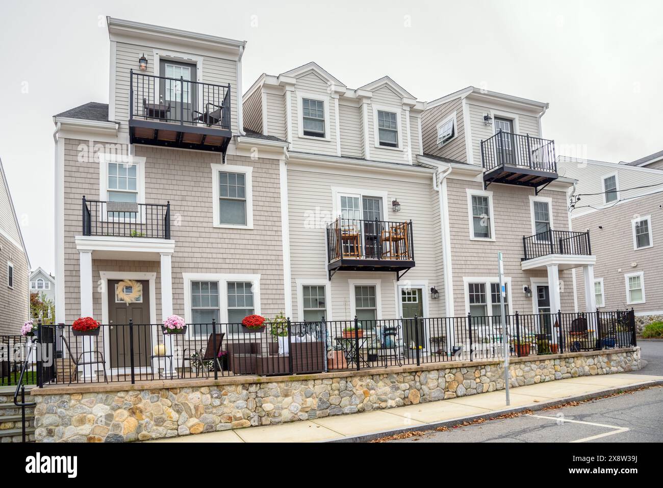 Modern row houses along a street on an overcast autumn day Stock Photo ...