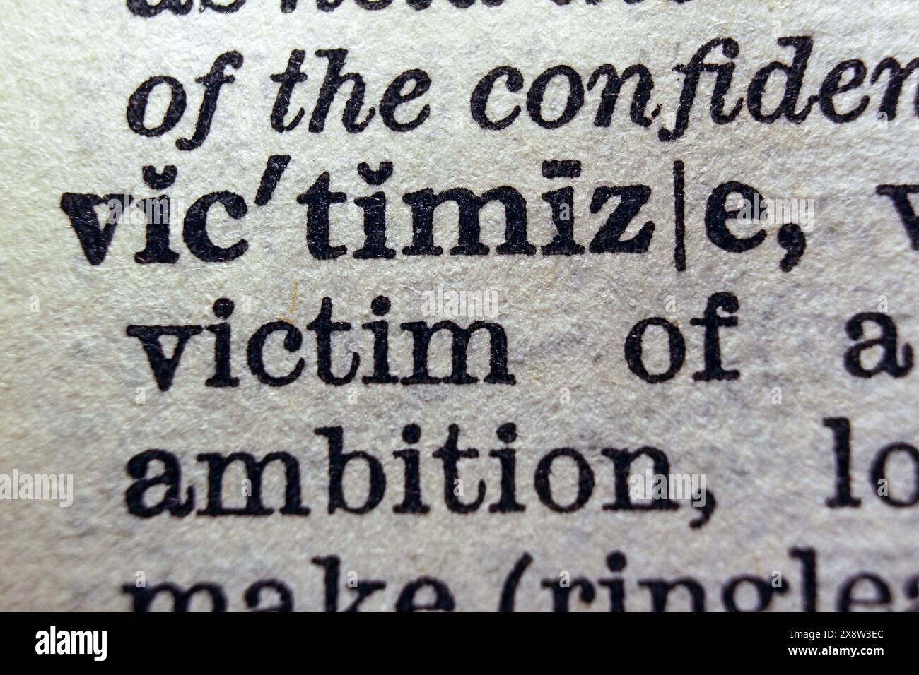 Word victimize on dictionary page, macro close-up Stock Photo - Alamy