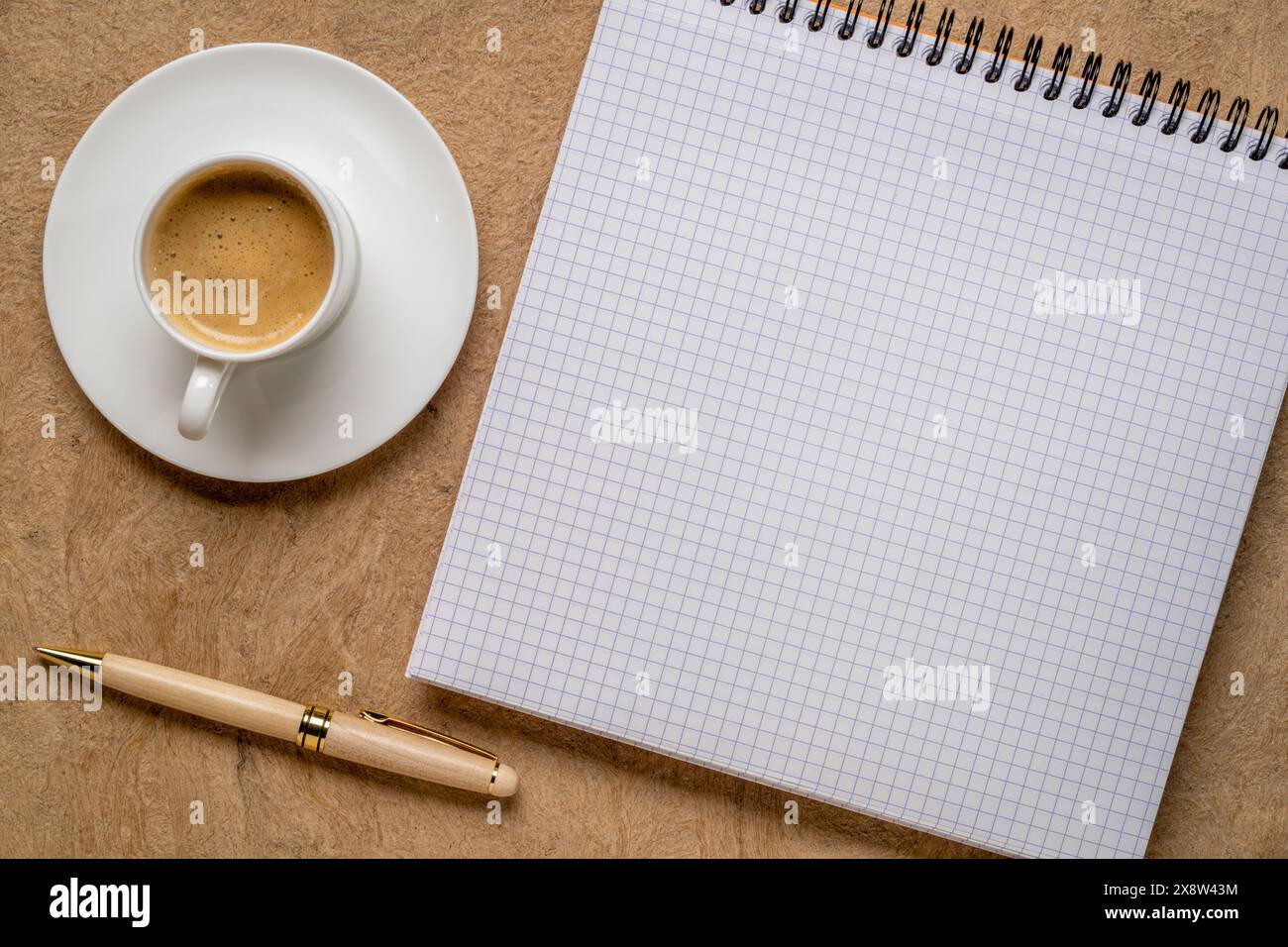 blank spiral notebook with grid paper, flat lay with coffee on textured ...