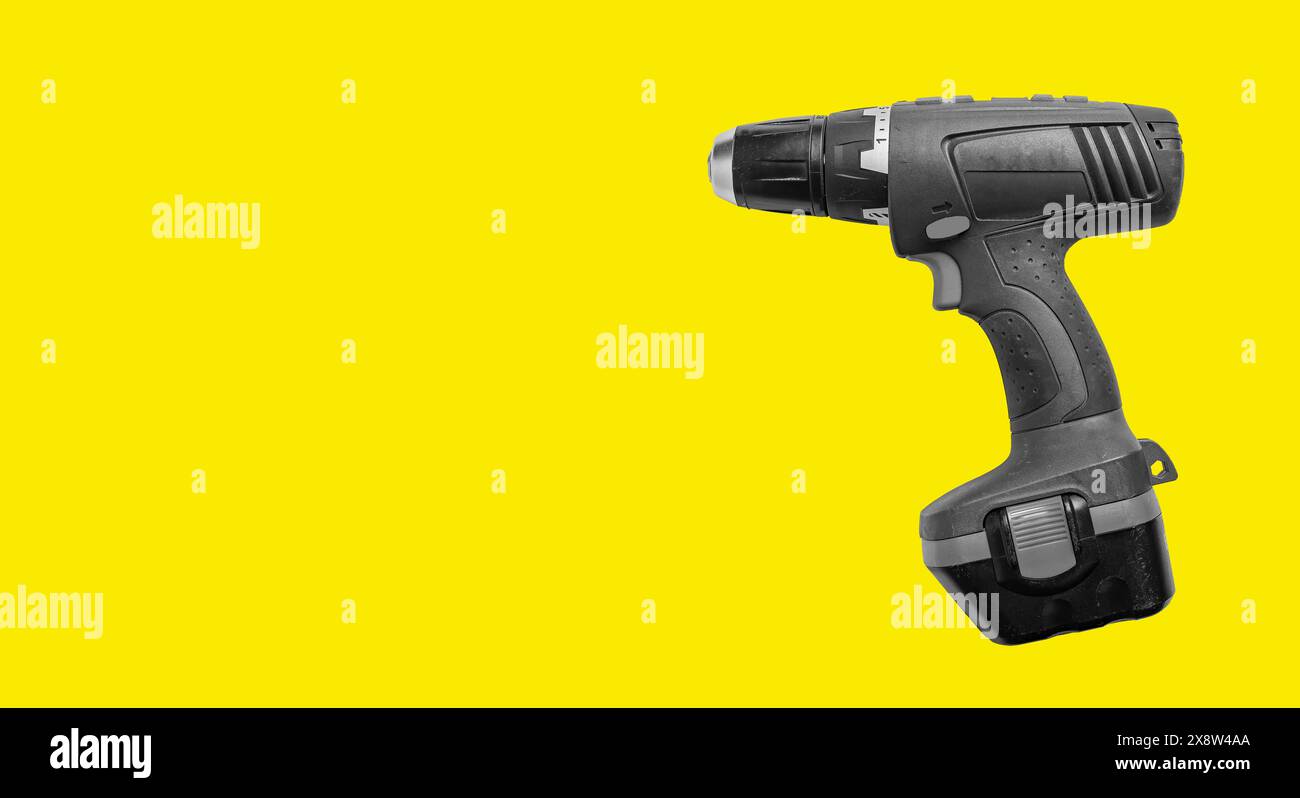 Electric screwdriver in construction and repair work. Industrial tool ...