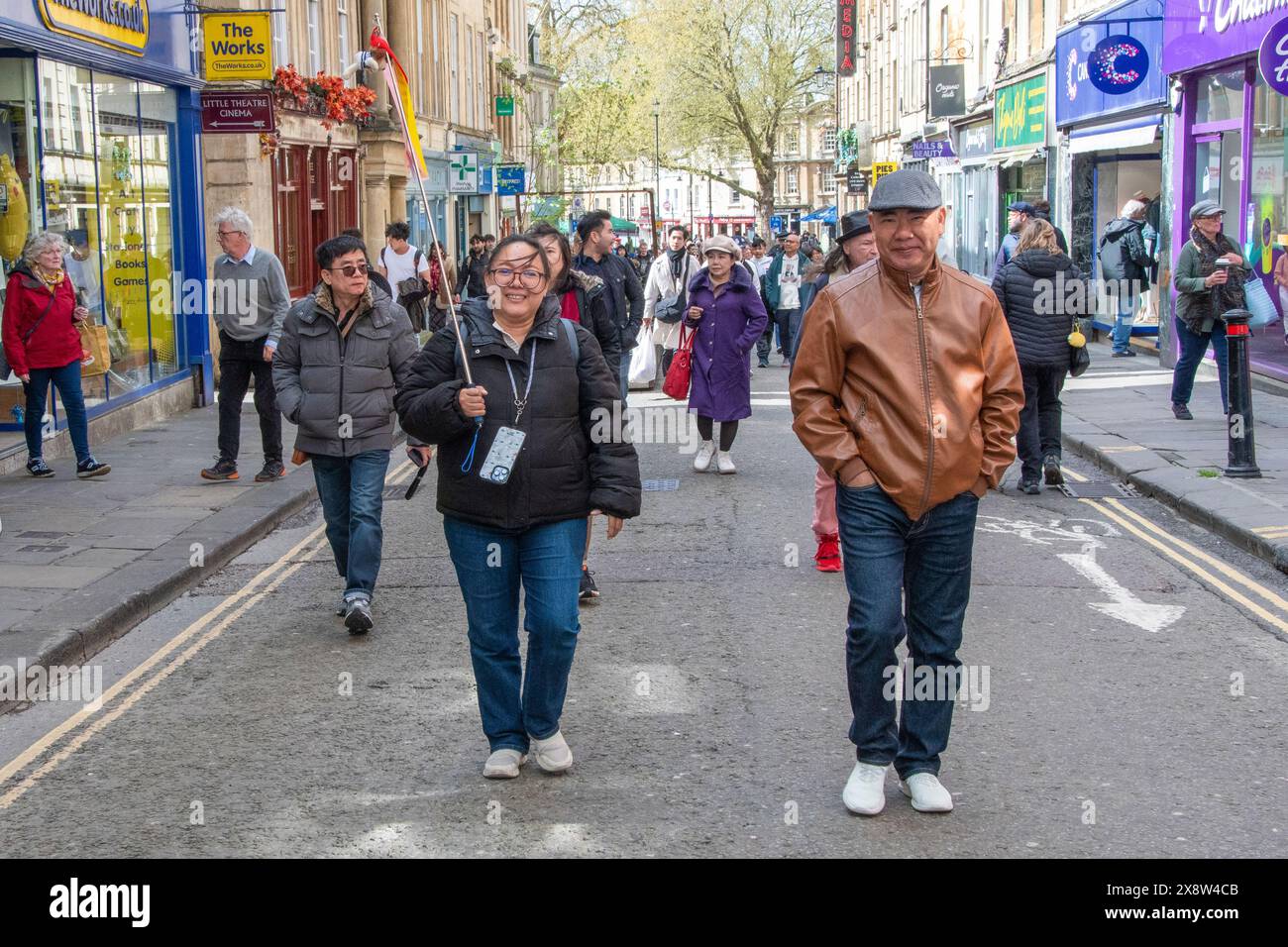 Tour Guide leading a group of tourists on a walking tour arounf the ...