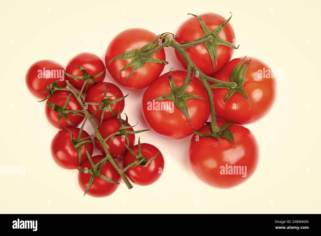 Organic red cherry tomato clusters of different size isolated on white ...