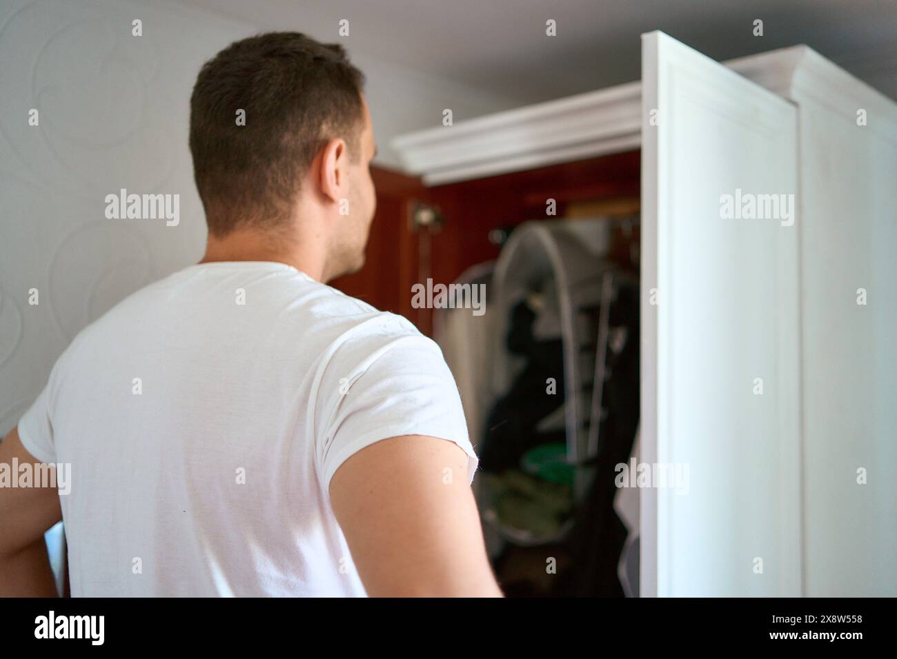 Man looking in wardrobe choose hi-res stock photography and images - Alamy