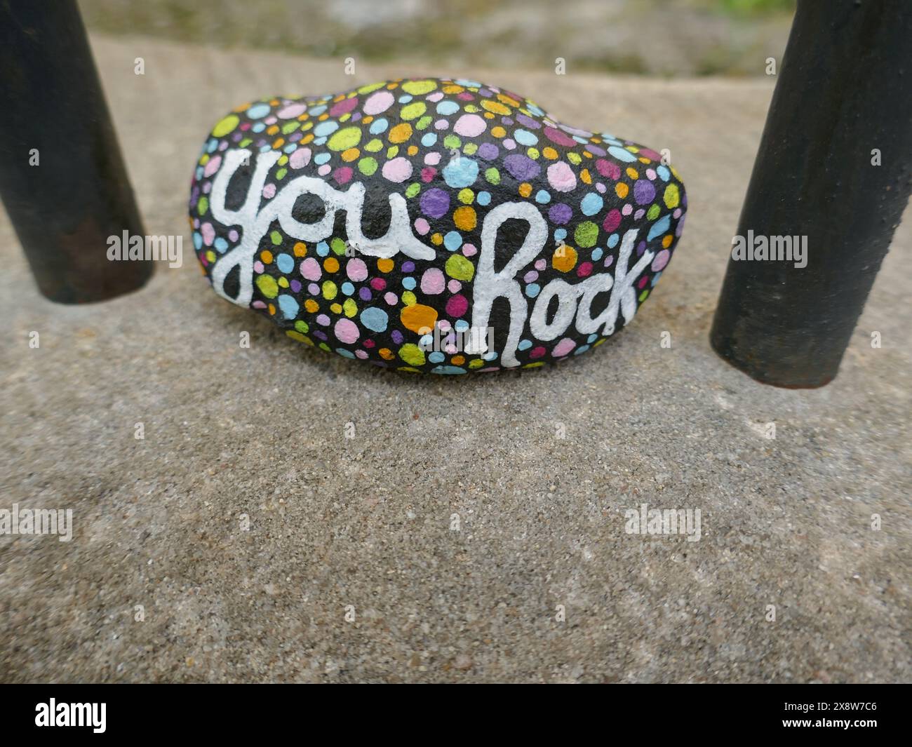 You rock kindness rock between two metal bars Stock Photo - Alamy