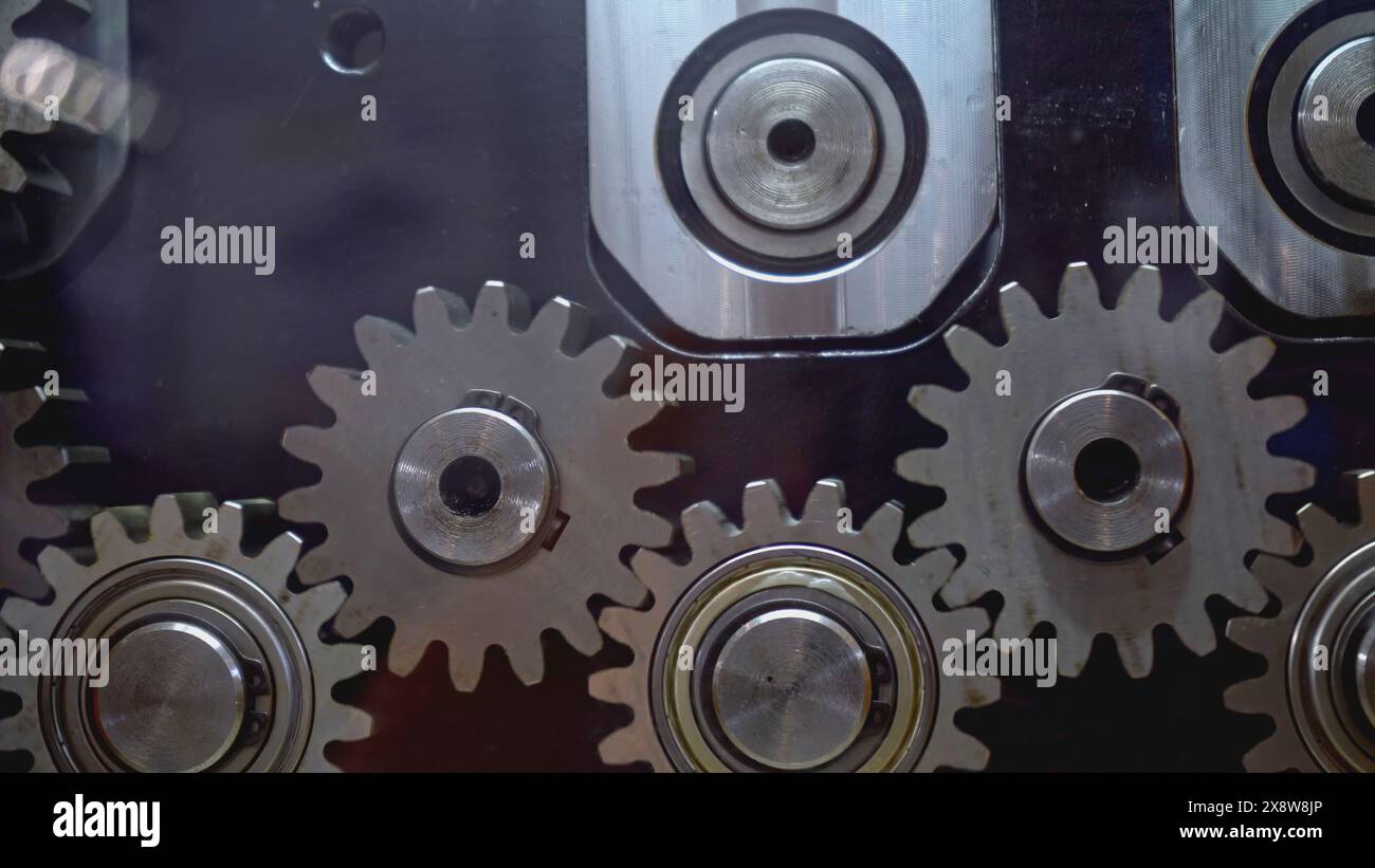 Mechanism with rotating gears. Media. Shiny metal gears rotate in ...