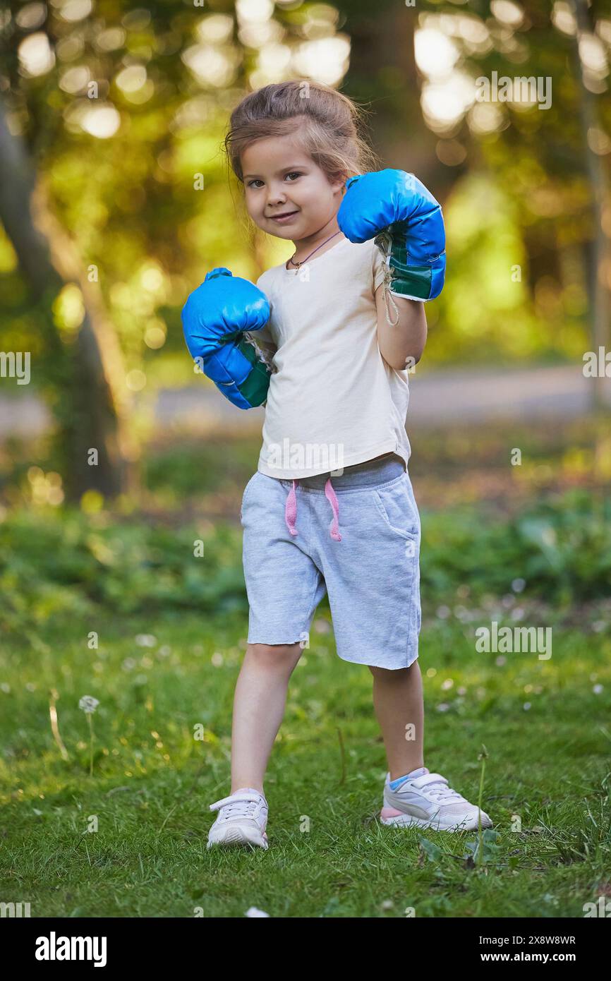 Charming child doing boxing in the backyard on the Sunset Stock Photo ...