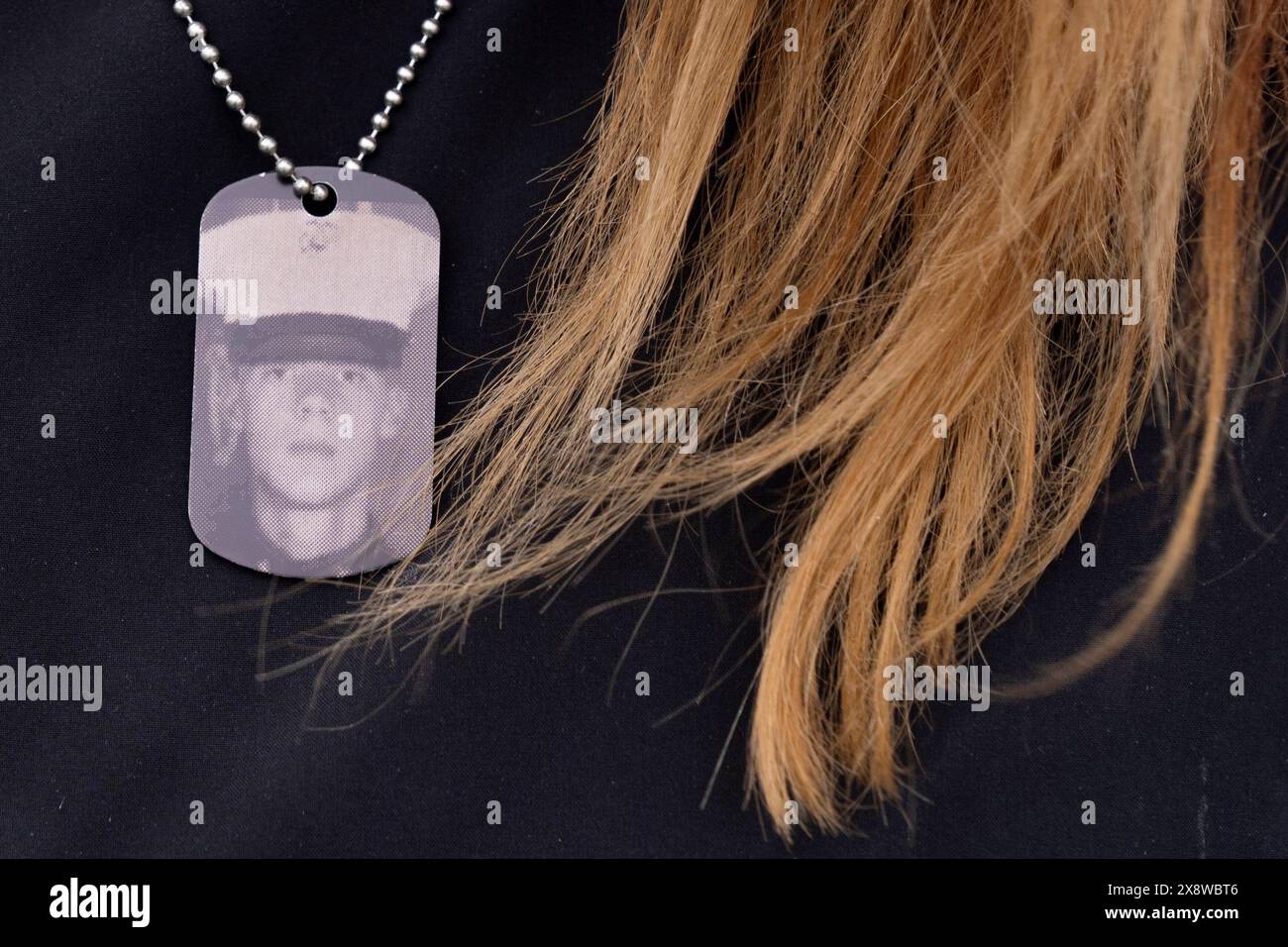 Krista Meinert, of Racine, Wisc., wears a dogtag with a photo of her ...