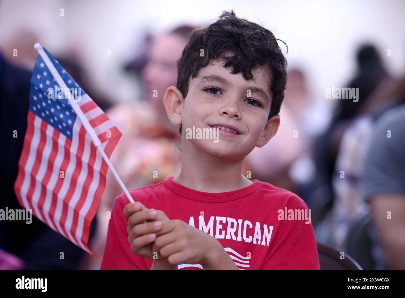 New York, USA. 27th May, 2024. Six year-old Noah holds an America Flag ...