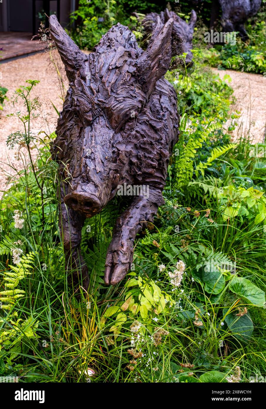 Boar statue in the green grass on display for sale at the 2024 RHS ...