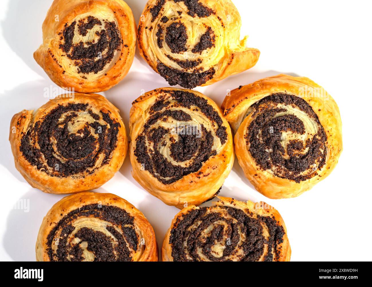Baked Poppy seed snails against white background Stock Photo - Alamy