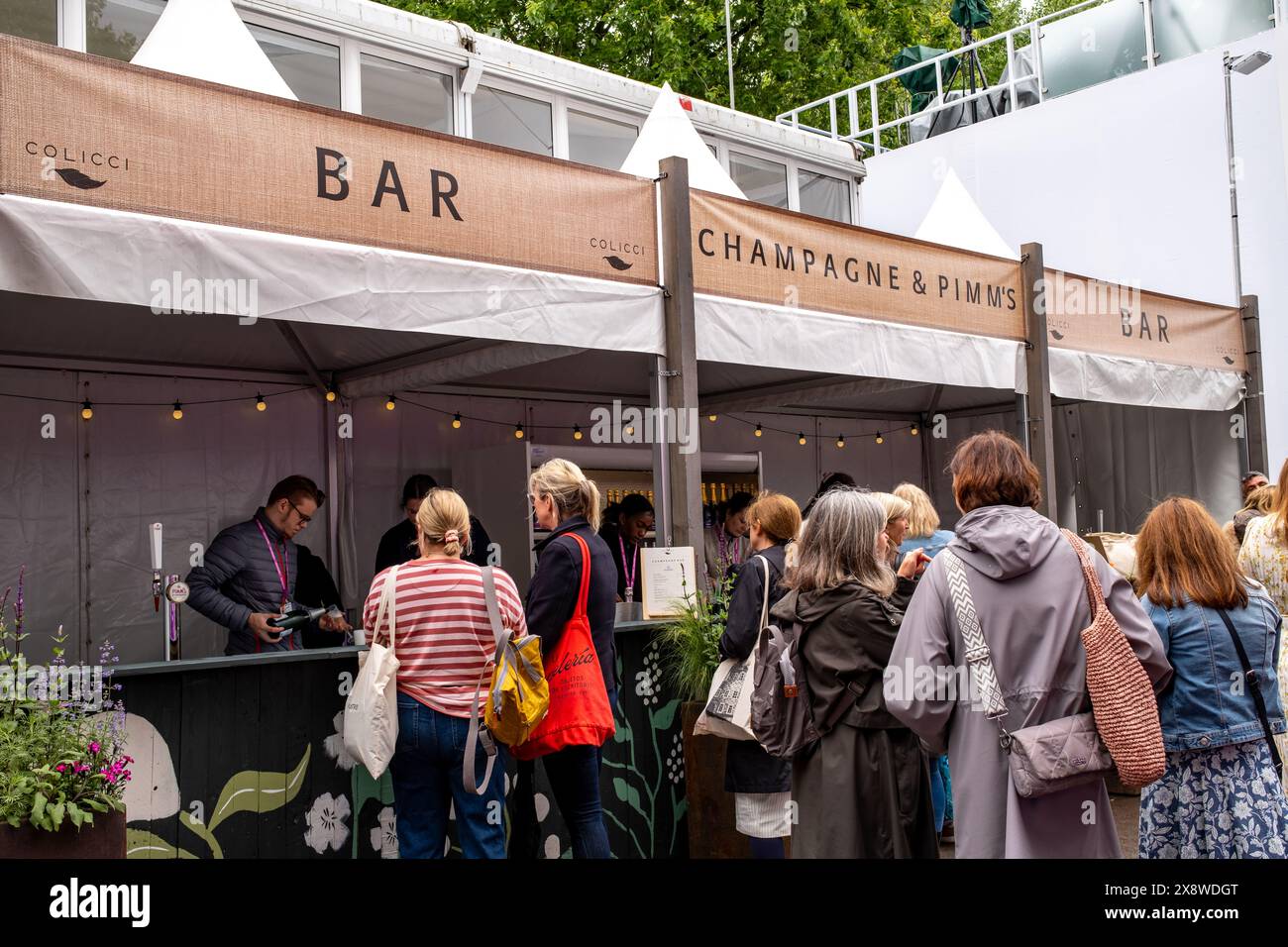 A group of ladies queuing to buy drinks at the Champagne and Pimms bar ...