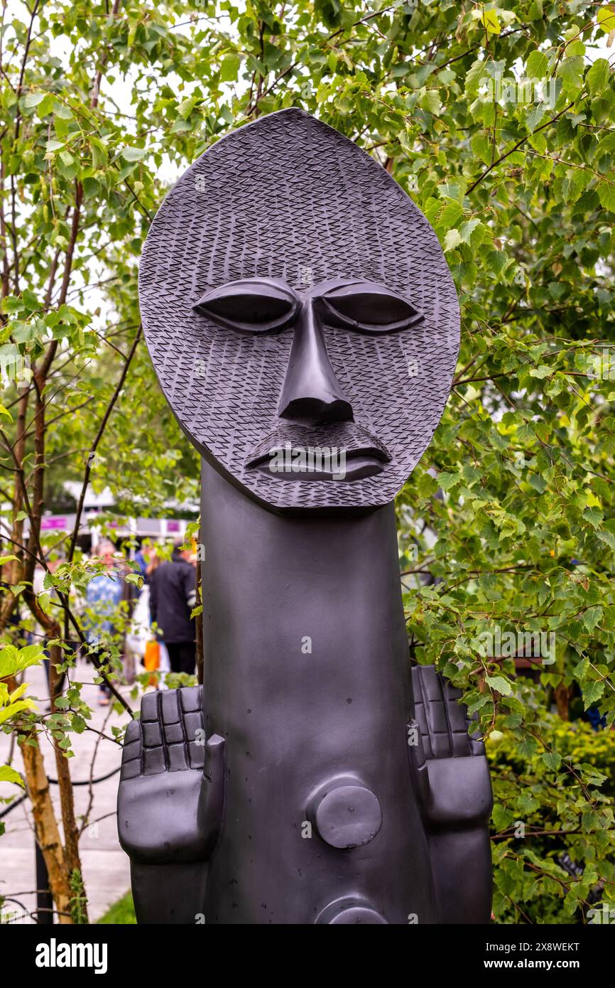 Tribal inspired statue among the leaves Stock Photo - Alamy