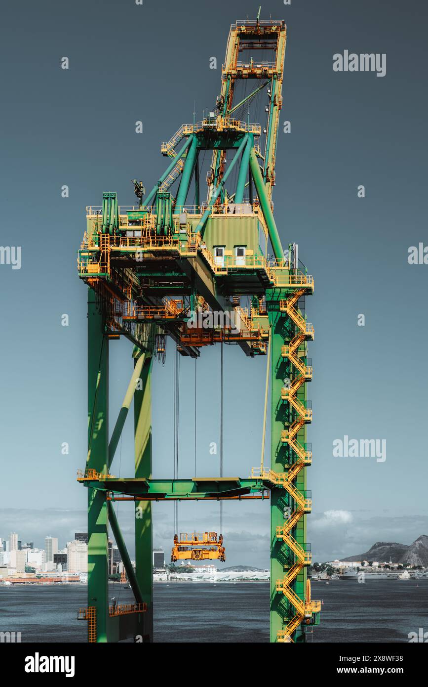 Close-up view of a large industrial crane at a port, with yellow and ...