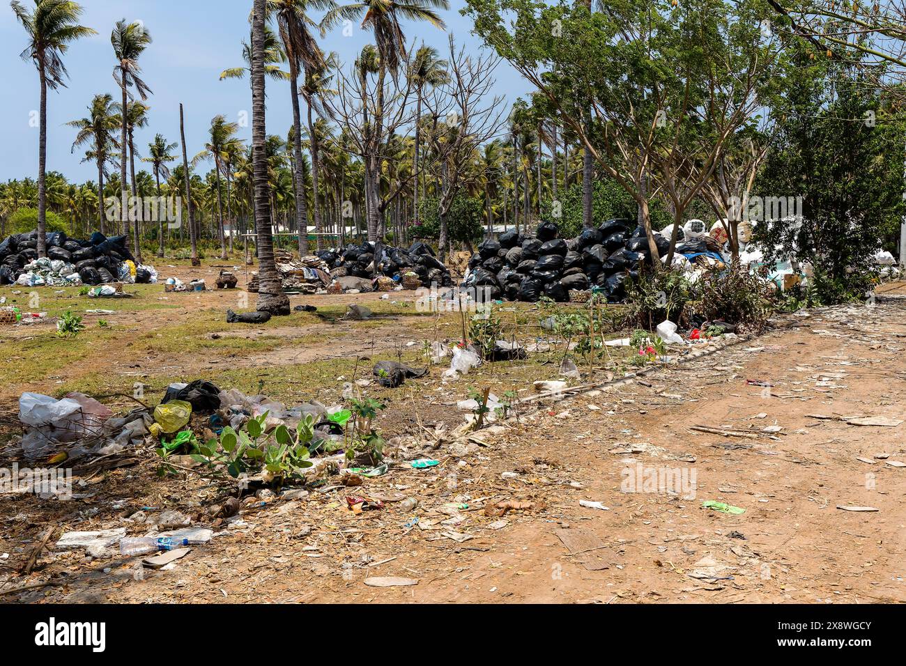 uge amounts of plastic and other garbage stacked and blowing on the ...
