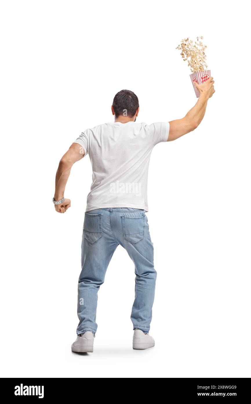 Rear view shot of a happy young man cheering with popcorn isolated on ...