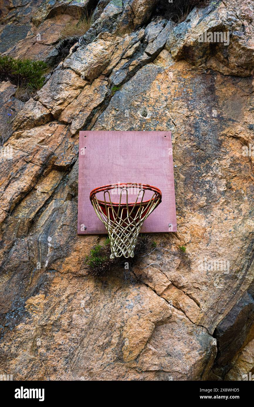 Basket ball basket hanging from a stone cliff face Stock Photo - Alamy