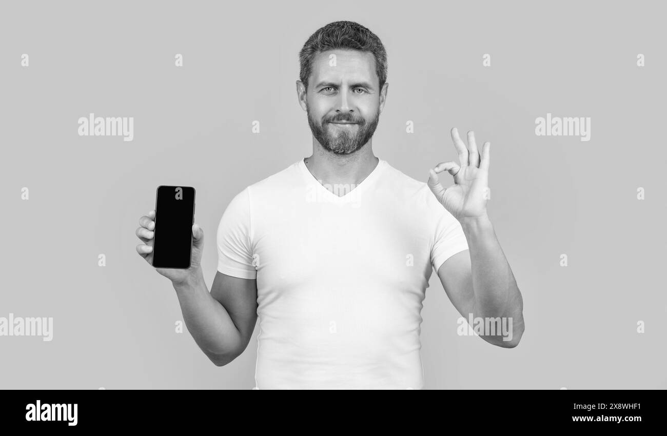 man showing phone screen with copy space show ok. man showing phone ...