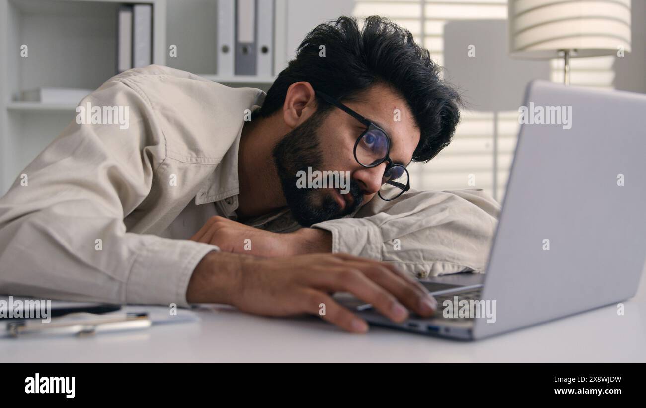 Lazy weary sleepy male manager tired exhausted Arabian Indian ...