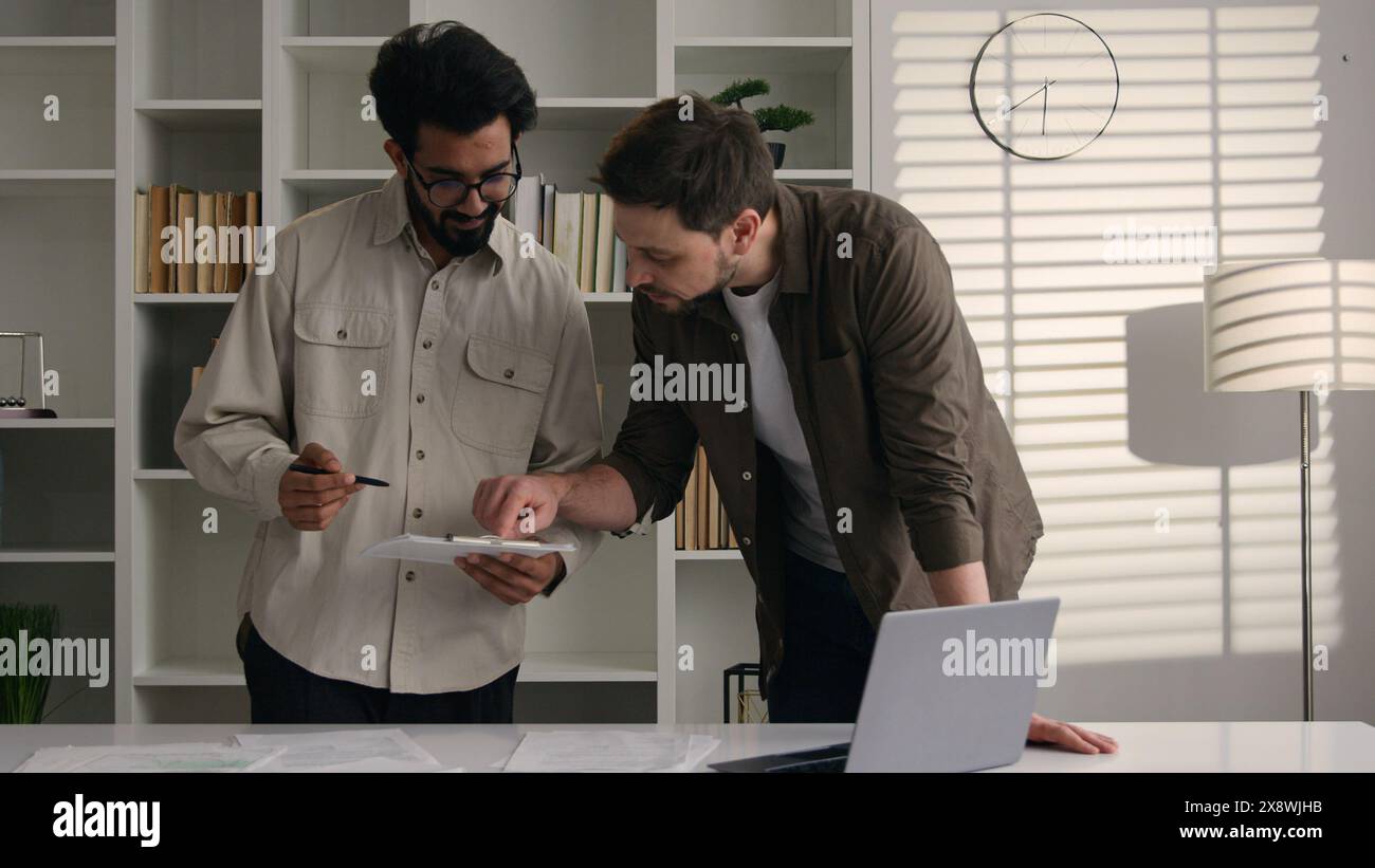 Two multiethnic colleagues businessmen business partners at office ...