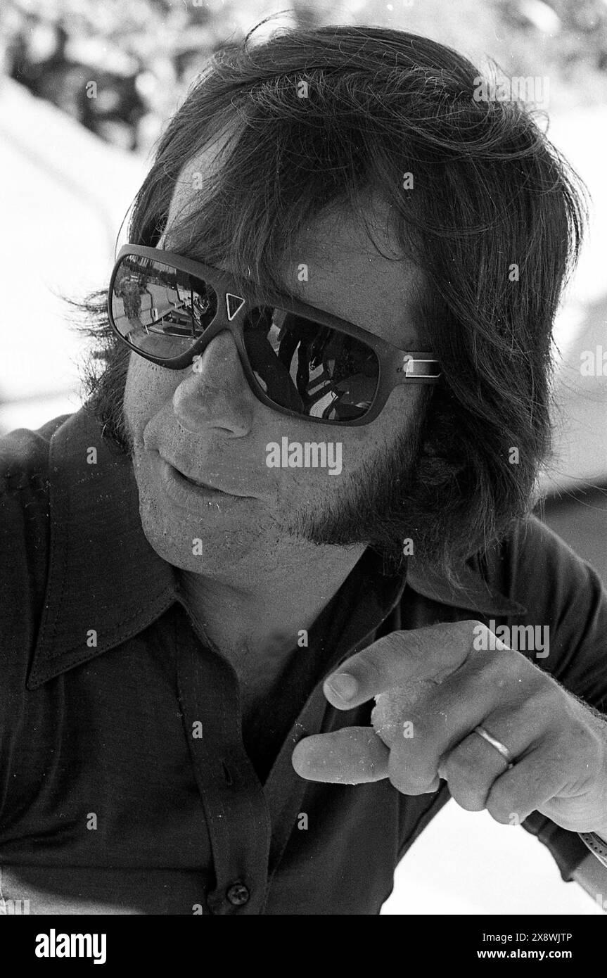 Brazilian car racer Emerson Fittipaldi (with sunglasses) takes his ...