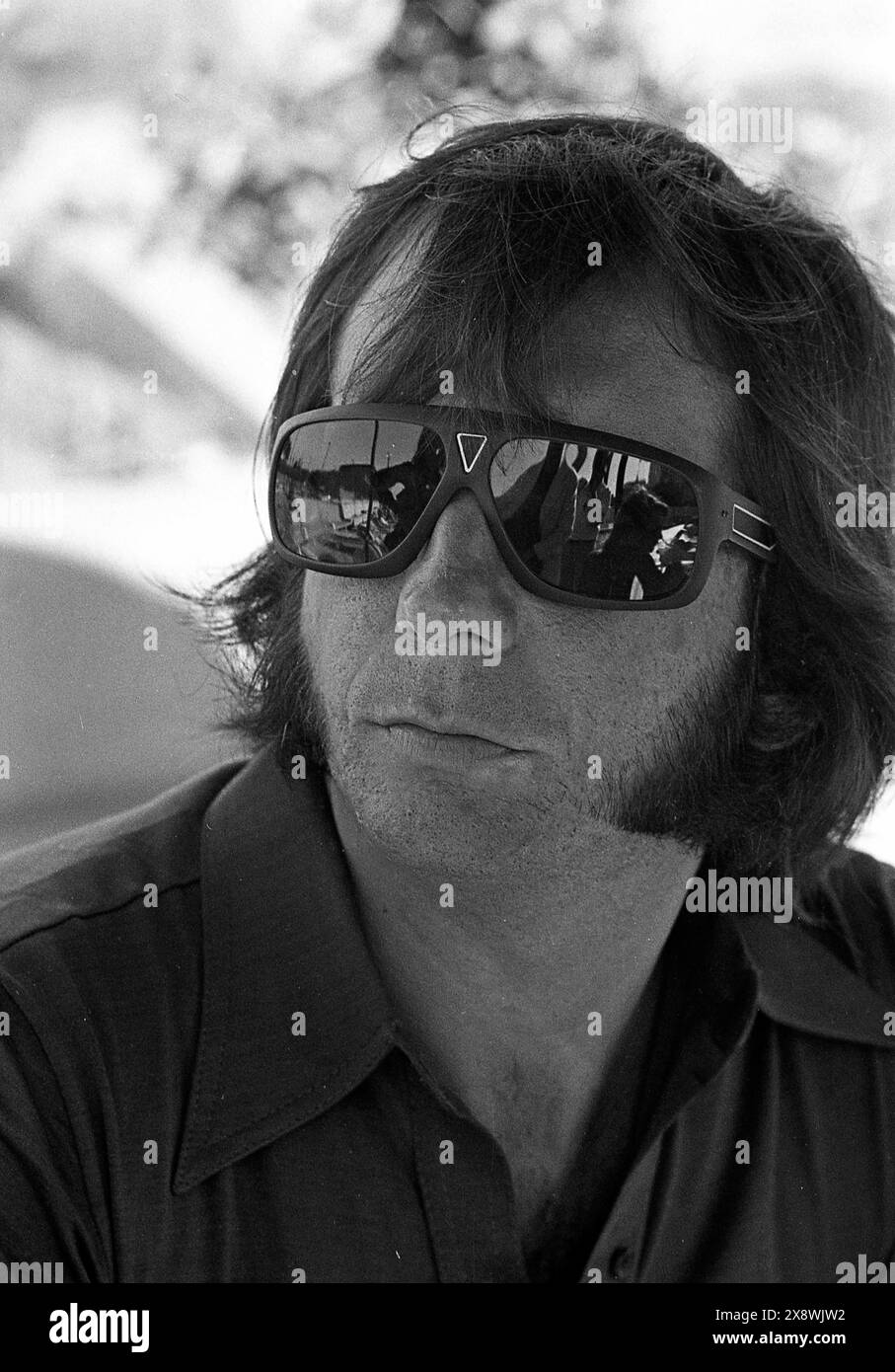 Brazilian car racer Emerson Fittipaldi (with sunglasses) takes his ...
