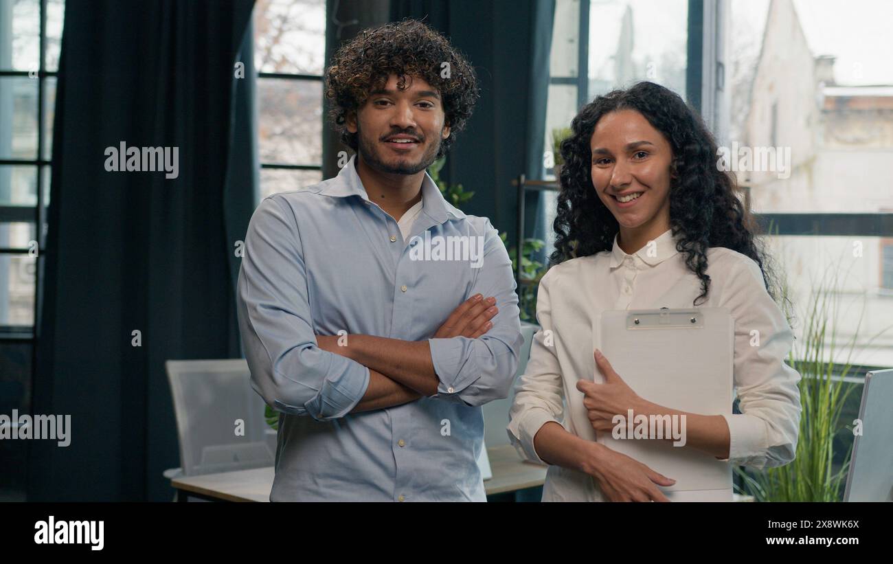 Two smiling entrepreneurs colleagues multiracial team Arabian man ...