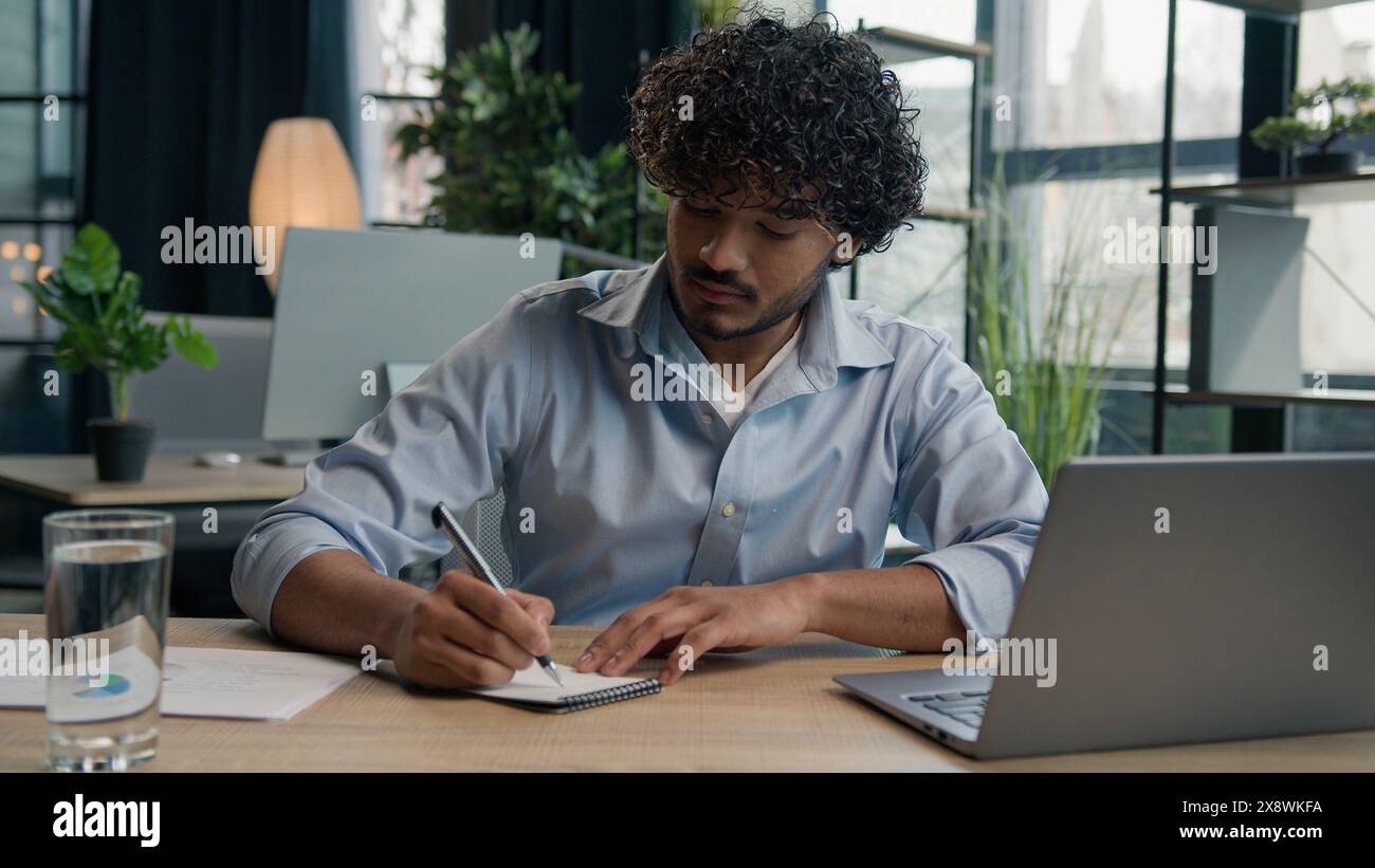 Arabian Indian latin man businessman guy write business notes ideas in ...