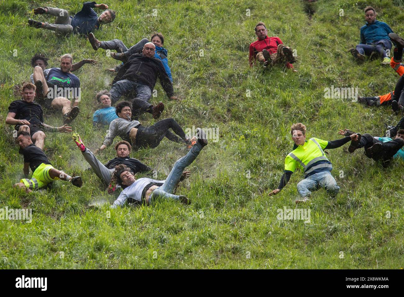 Men chase cheese during the first race of the Cooper’s Hill Cheese ...