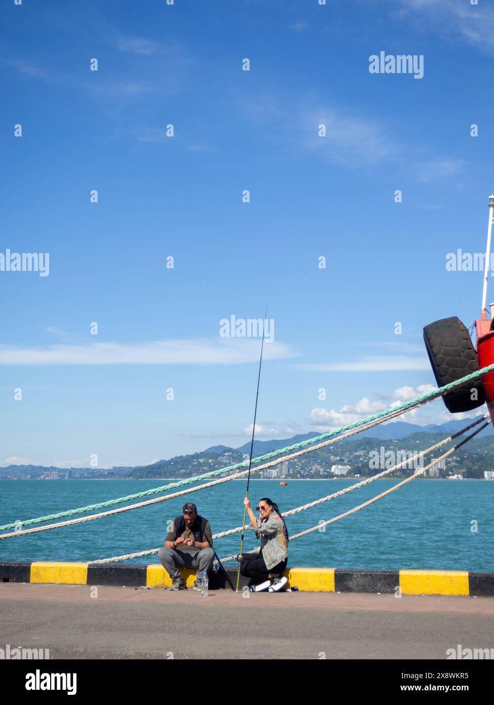 Batumi, Georgia. 05.18.2024 Vacationing people at the sea dock. Port of ...