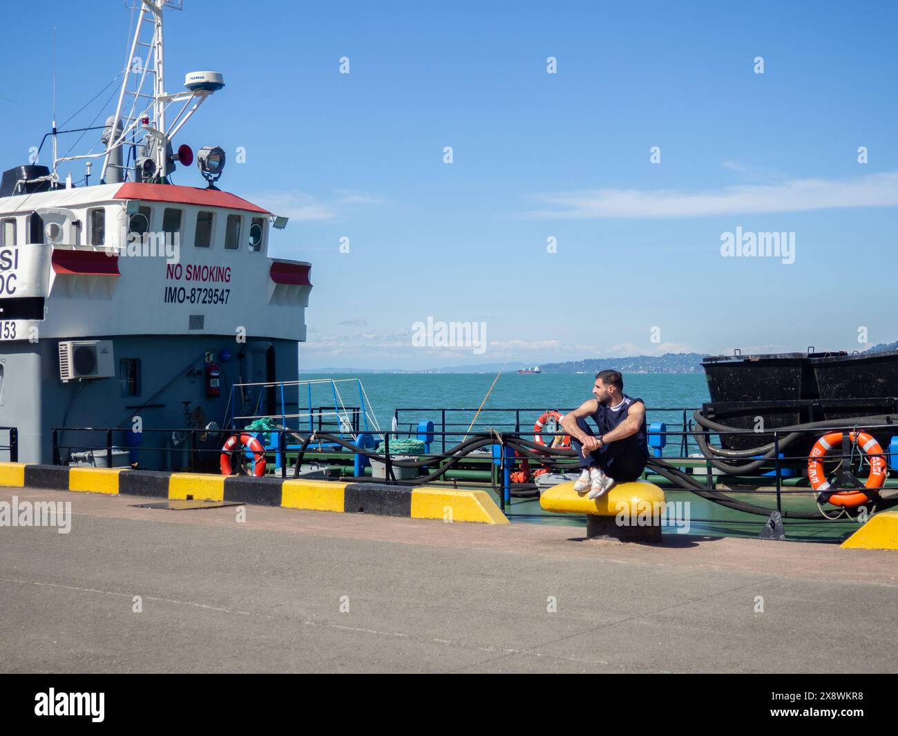Batumi, Georgia. 05.18.2024 Vacationing people at the sea dock. Port of ...