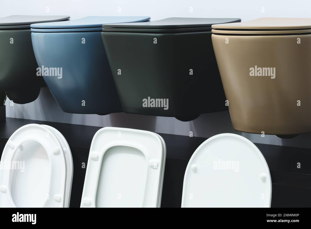A row of toilets with different colors and designs. The toilet on the ...