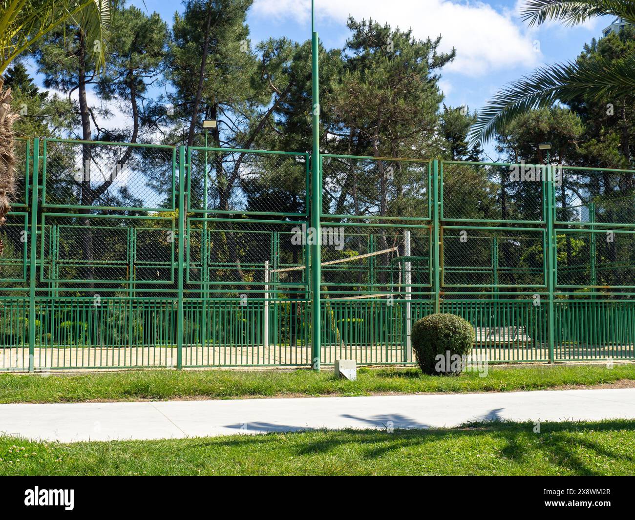 Empty volleyball court at the resort. Behind the net. Fenced area Stock ...